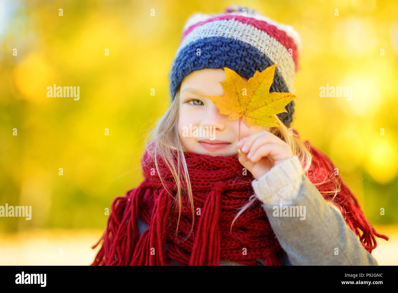 Cute little girl having fun on beautiful autumn day. Happy child ...