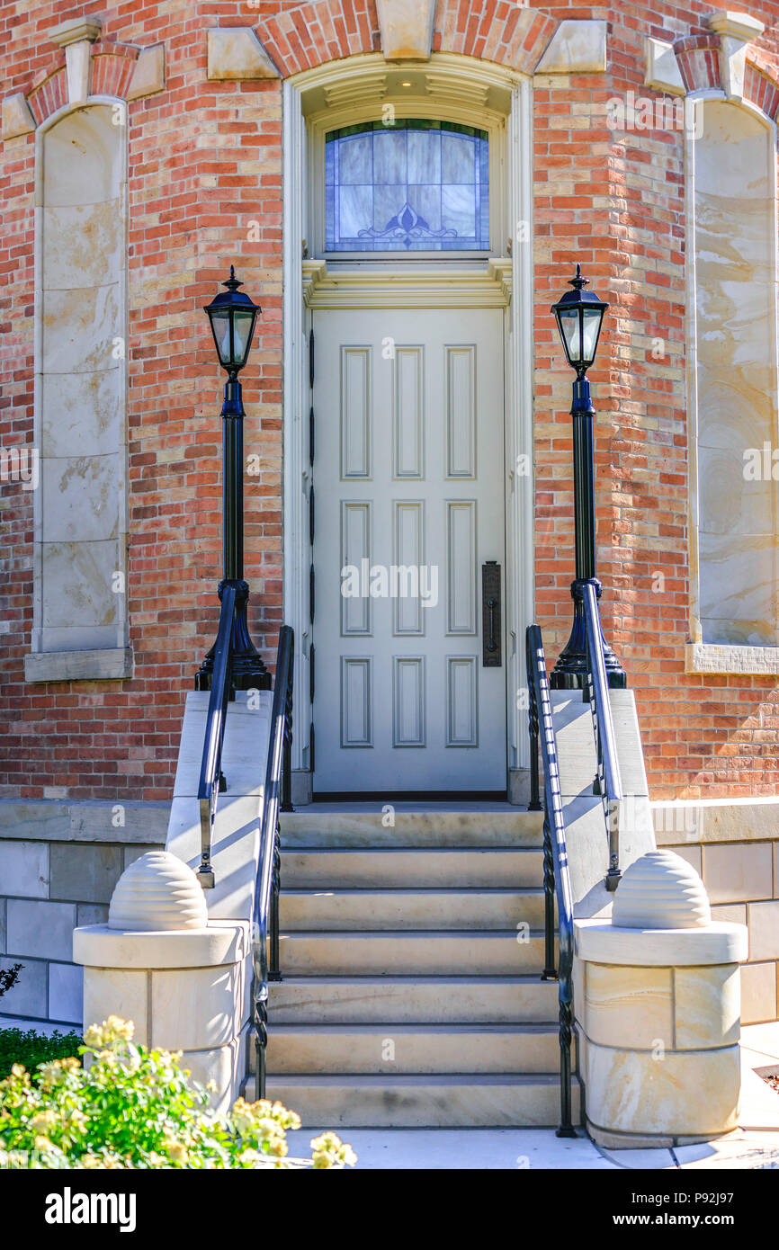 Tall door with stairs leading up Stock Photo - Alamy