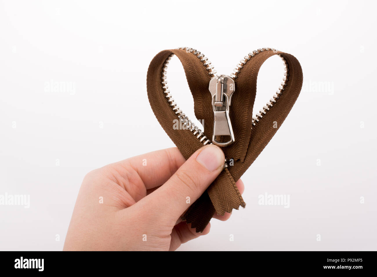 Heart shaped zipper on a white background Stock Photo - Alamy