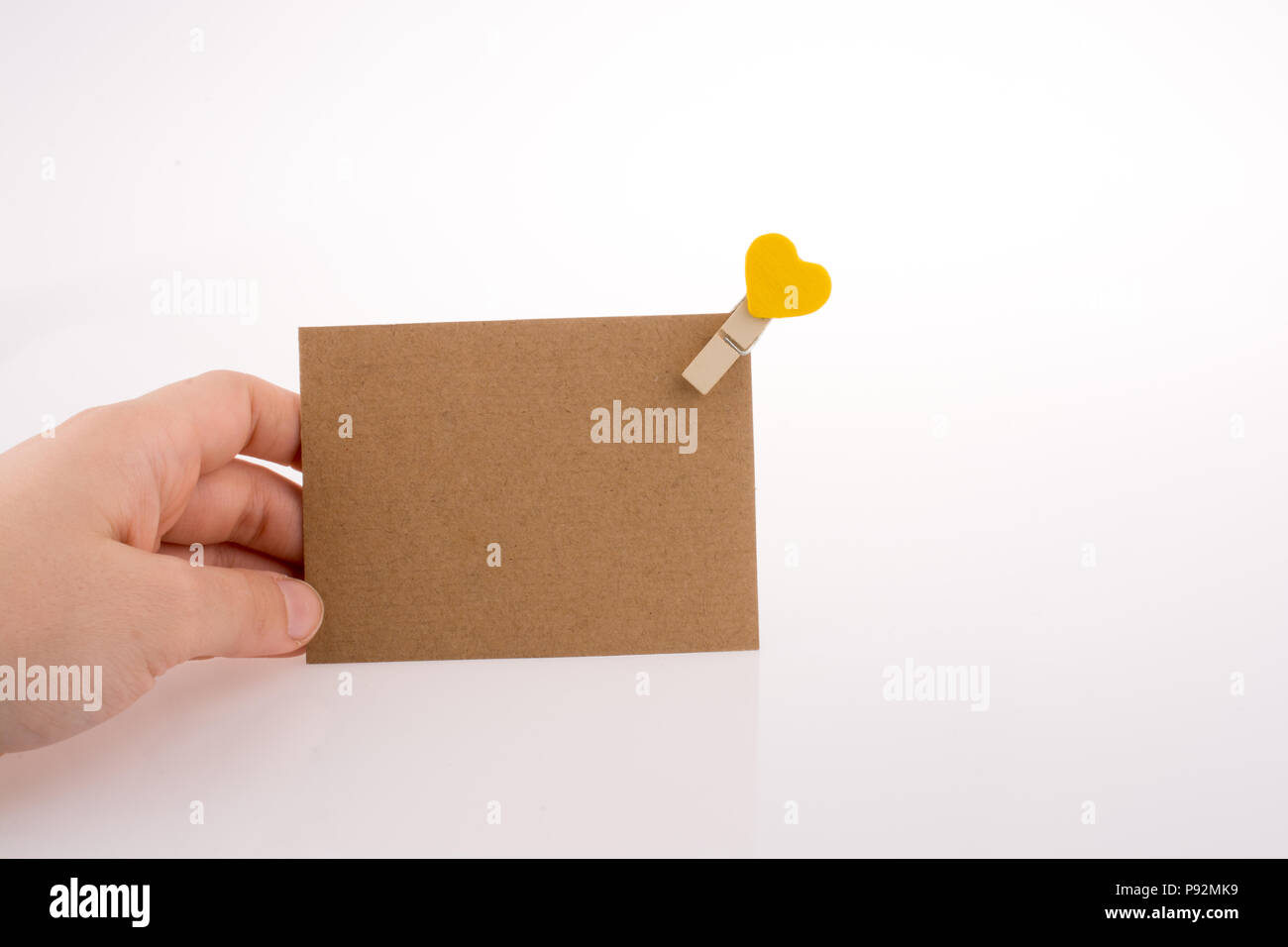 Hand holding a paper with a clip on it Stock Photo - Alamy