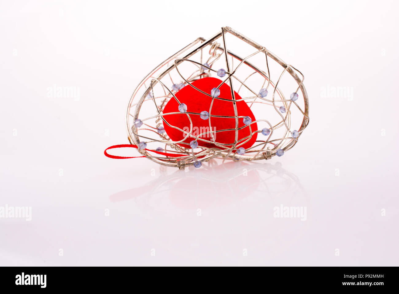 Heart in Heart cage on a white background Stock Photo - Alamy
