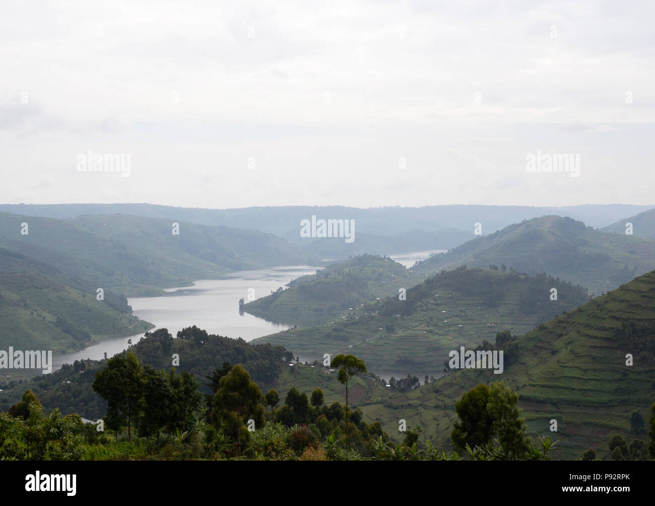 Landscape photograph of hills in a valley with winding river running ...