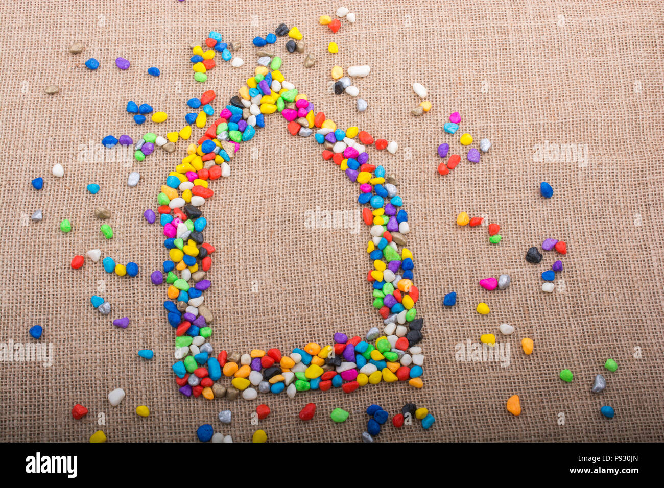 House form shaped by some colorful pebbles Stock Photo - Alamy