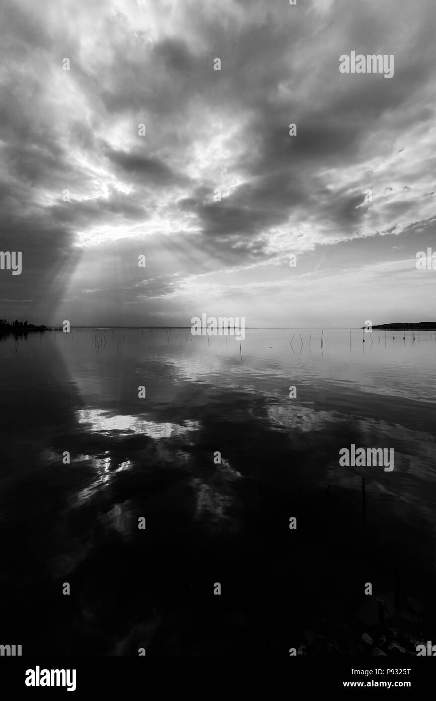 Perfectly symmetric and spectacular view of a lake, with clouds, sky ...