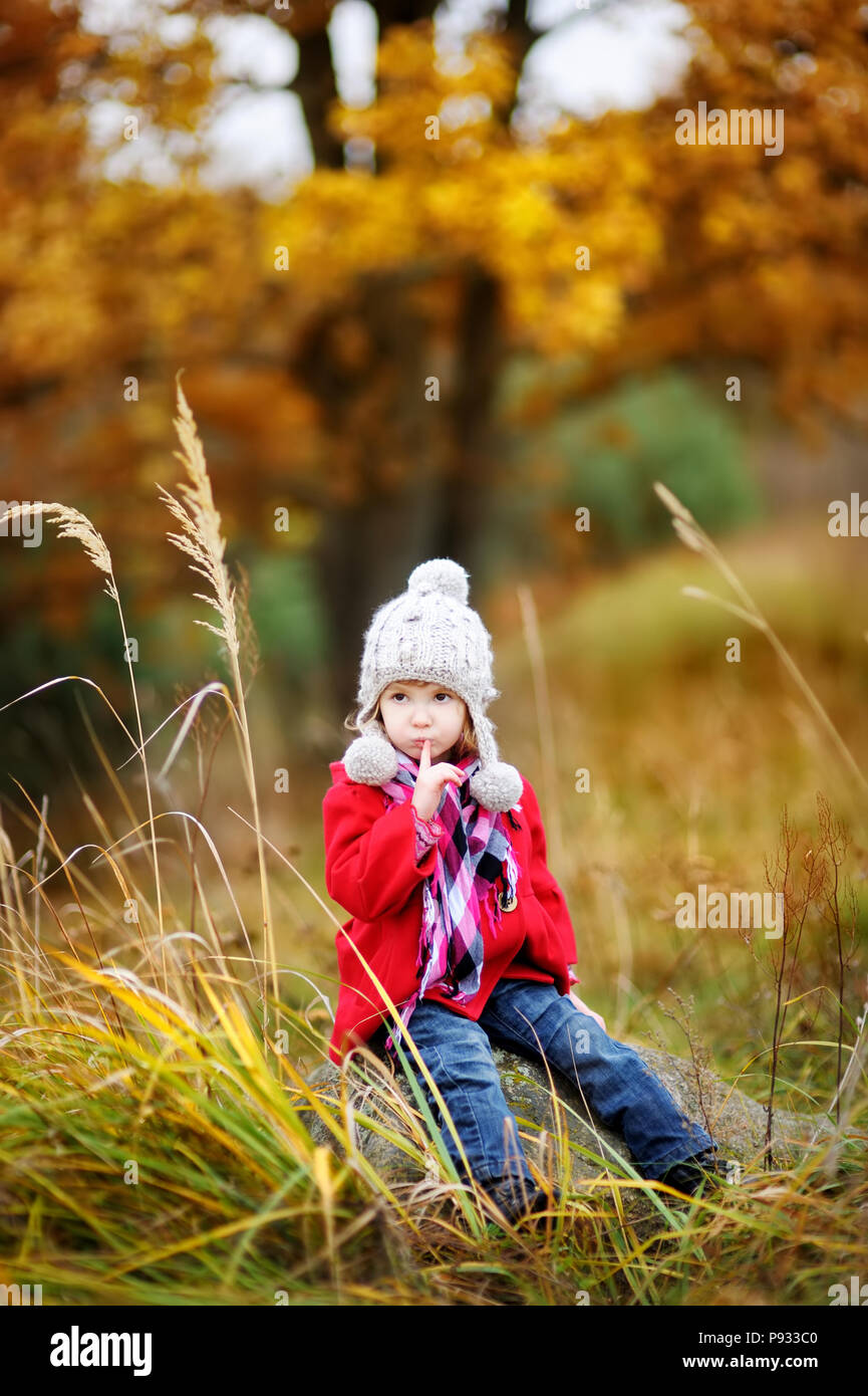 Cute little girl having fun on beautiful autumn day. Happy child ...