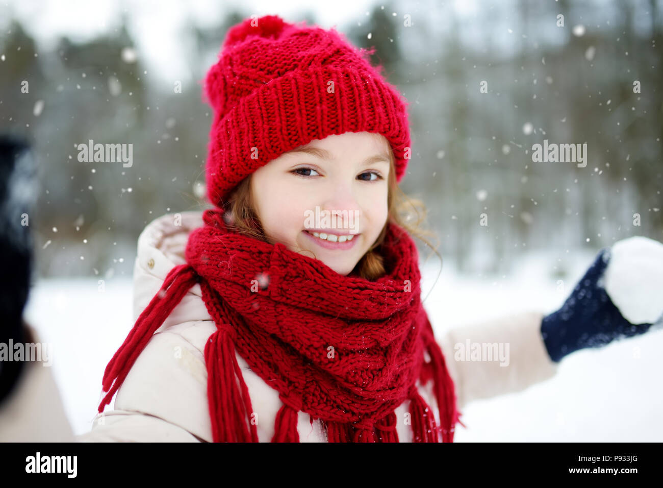 Adorable little girl having fun in beautiful winter park. Cute child ...