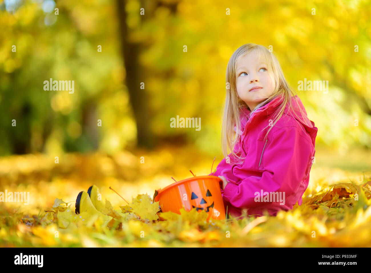 Cute little girl having fun on beautiful autumn day. Happy child ...