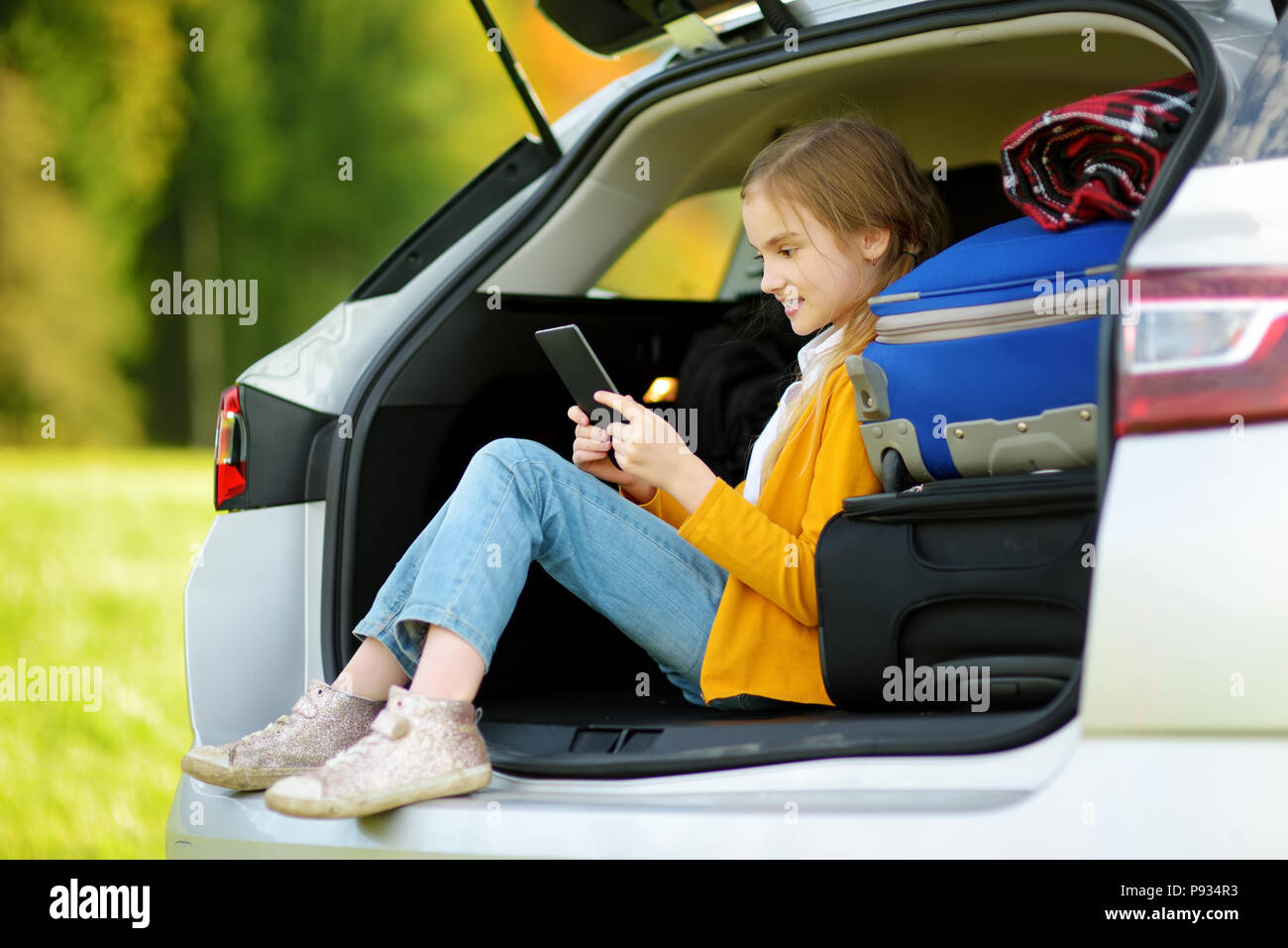 Adorable little girl ready to go on vacations with her parents. Kid ...