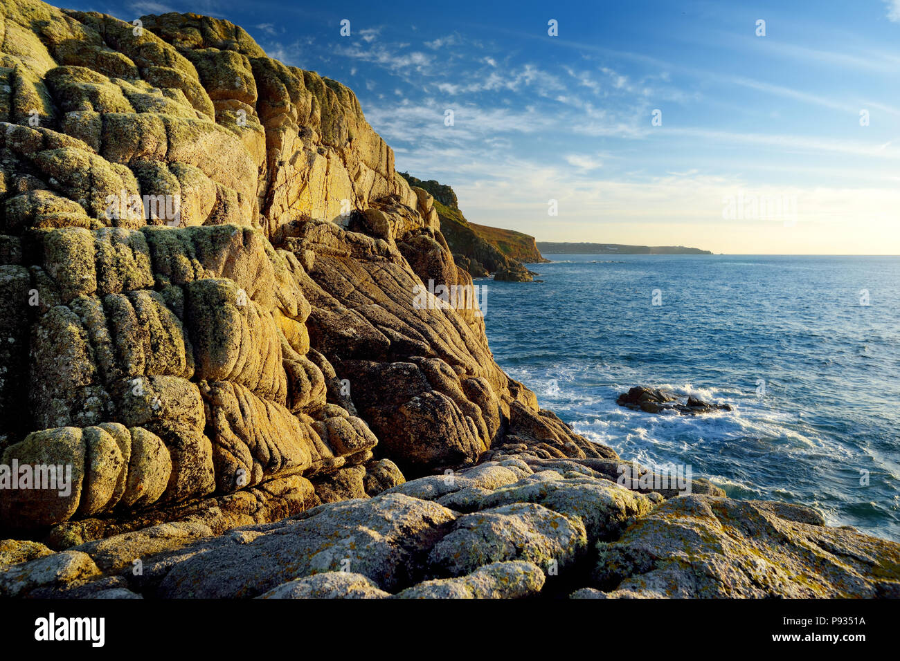 Scenic rugged Cornish coastline at Porth Nanven on sunny evening ...