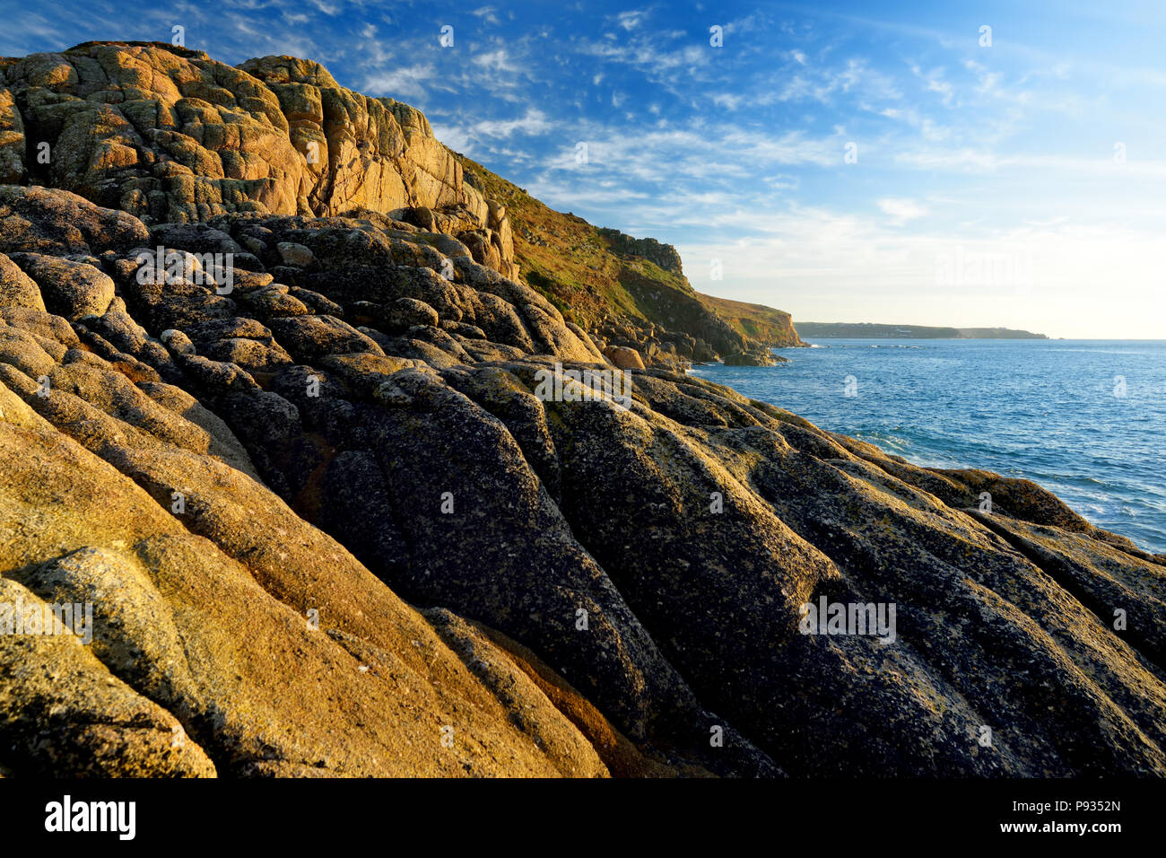 Scenic rugged Cornish coastline at Porth Nanven on sunny evening ...