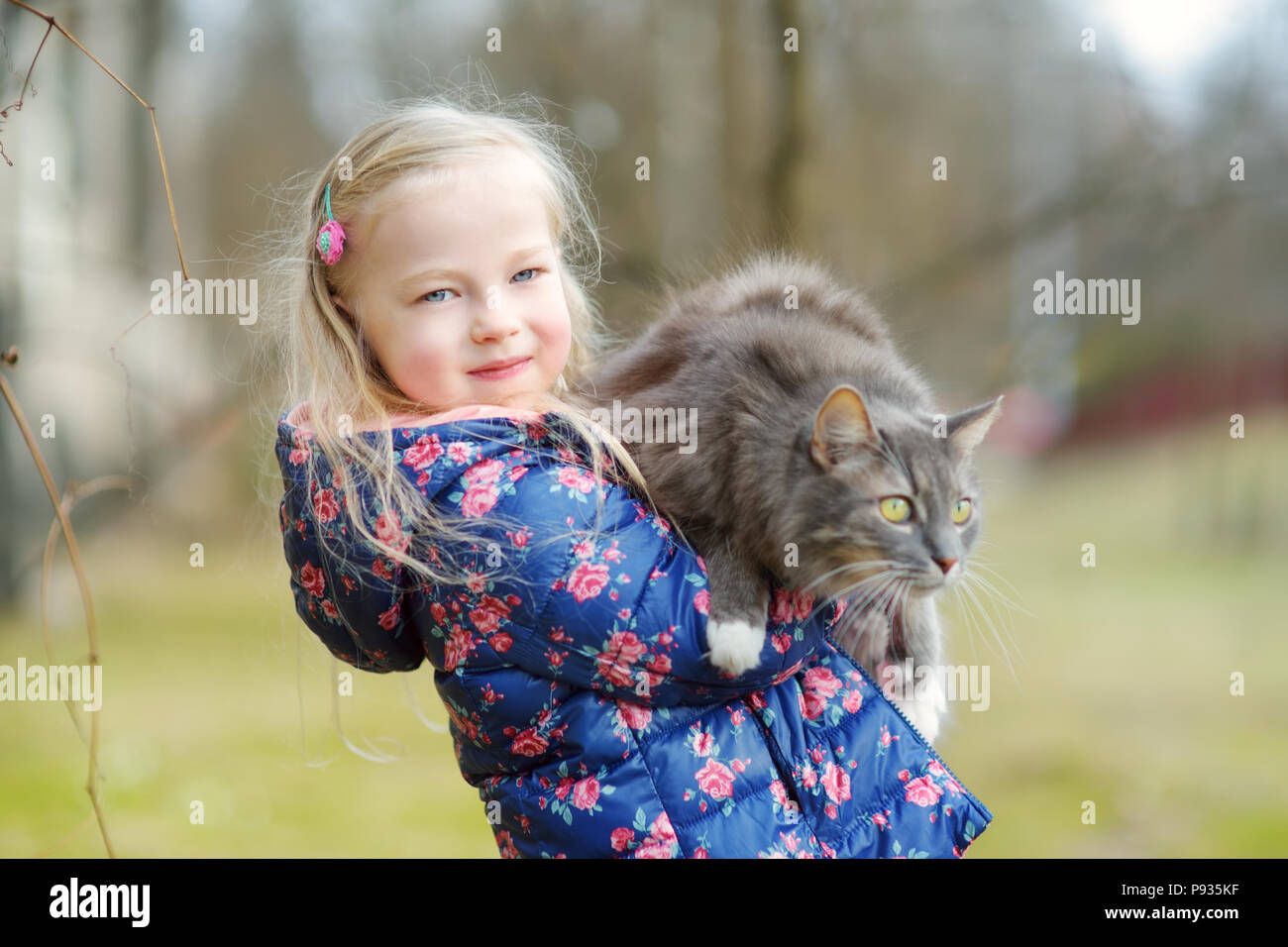 Cute little girl with her pet cat on chilly autumn day. Kids and ...