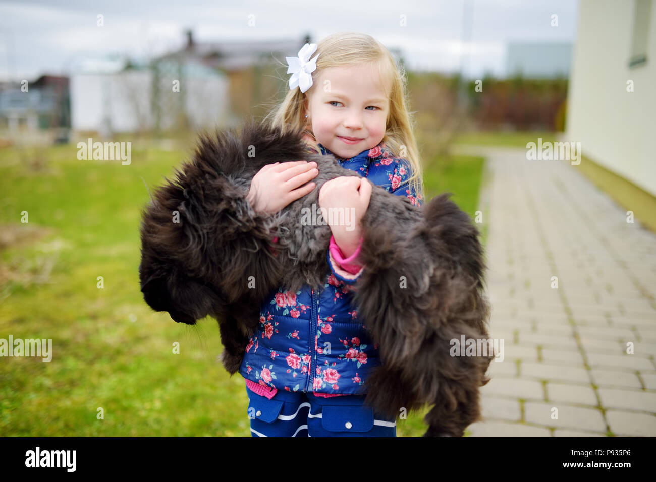 Cute little girl with her pet cat on chilly autumn day. Kids and ...