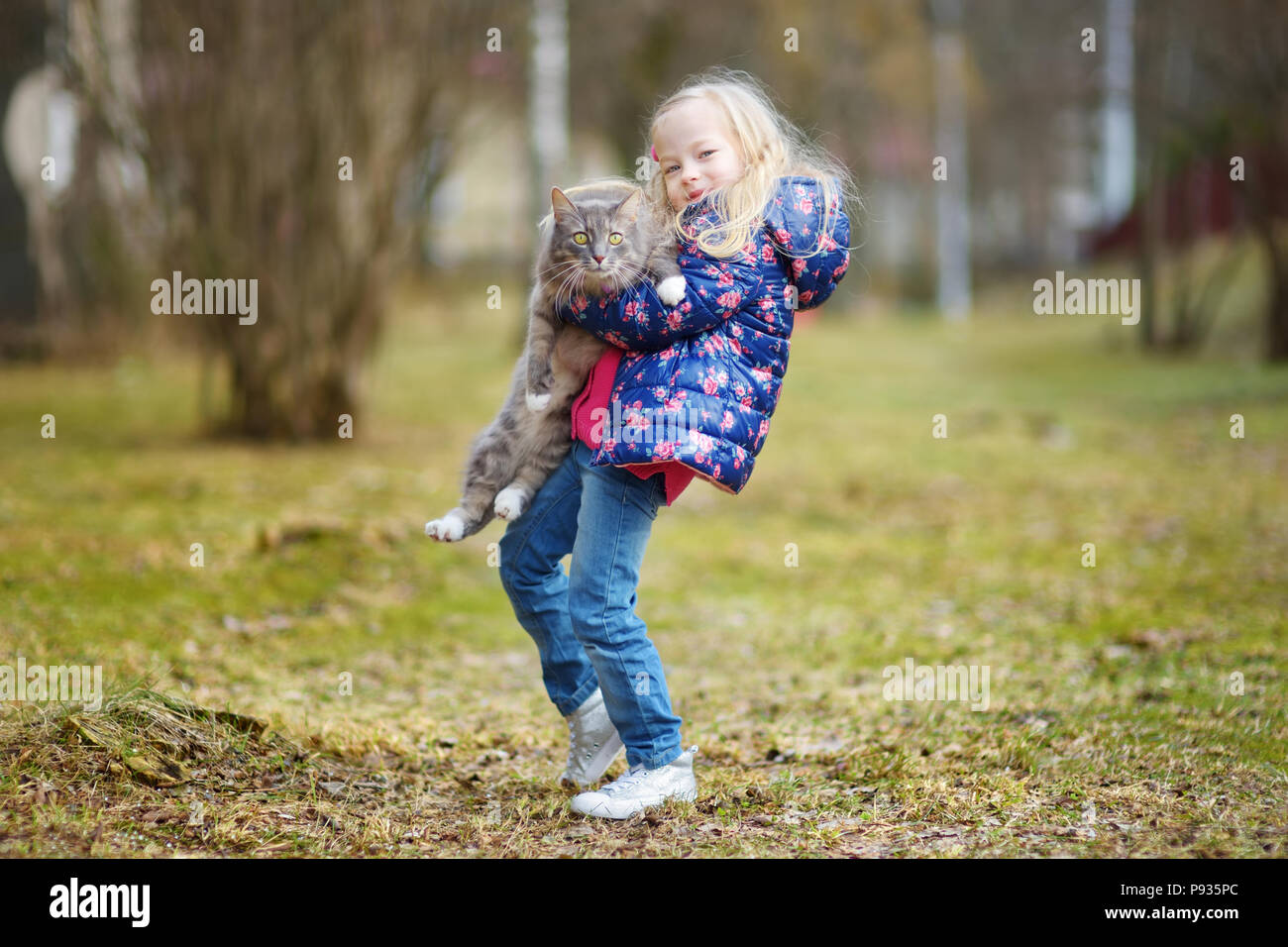 Cute little girl with her pet cat on chilly autumn day. Kids and ...