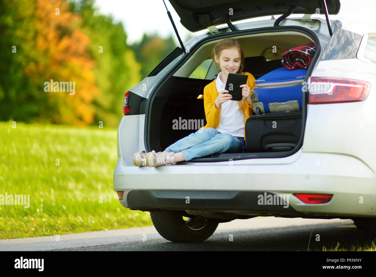 Adorable little girl ready to go on vacations with her parents. Kid ...