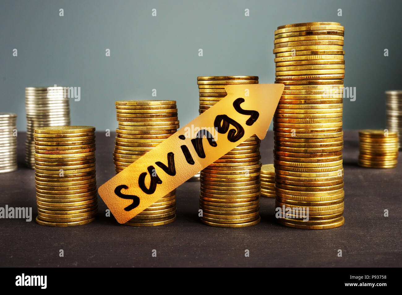 Savings growth. Arrow and coins stacks Stock Photo - Alamy