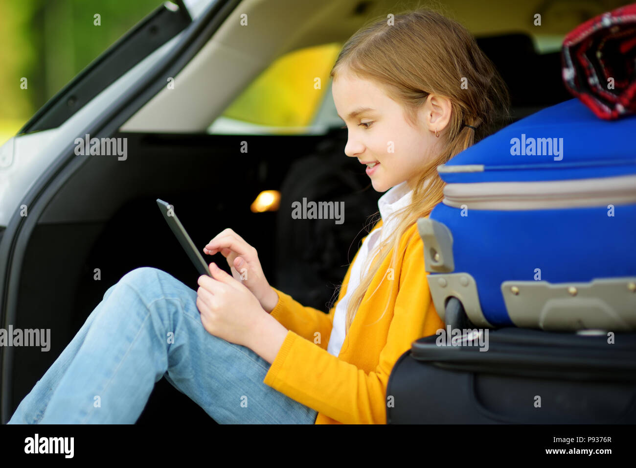 Adorable little girl ready to go on vacations with her parents. Kid ...