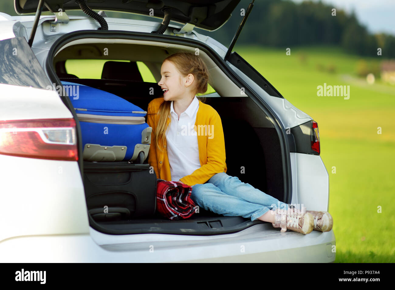 Adorable little girl ready to go on vacations with her parents. Child ...