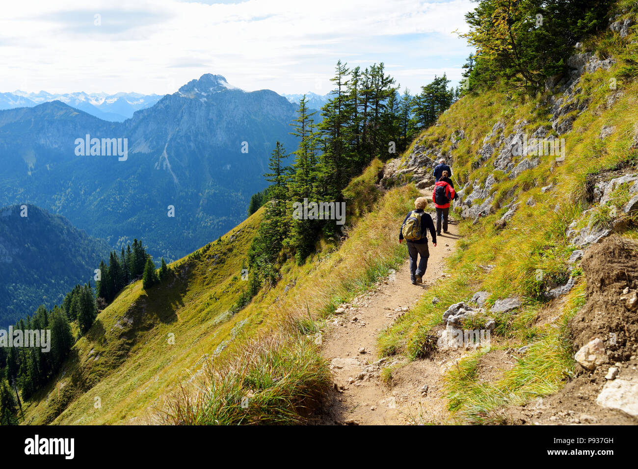 Tourists on hiking trails of picturesque Tegelberg mountain, a part of ...
