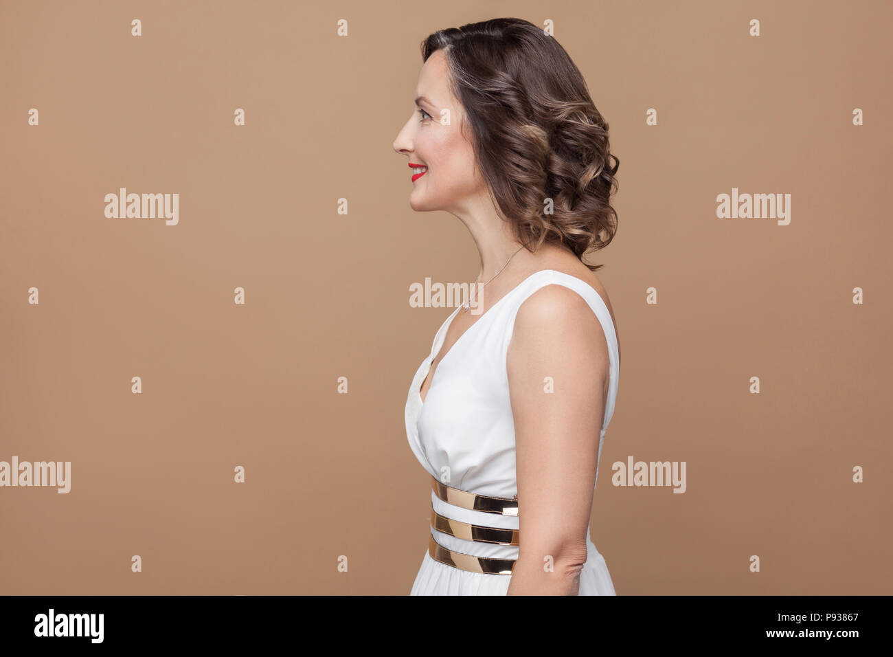 Profile side view of toothy smiled happy middle aged woman. Emotional ...