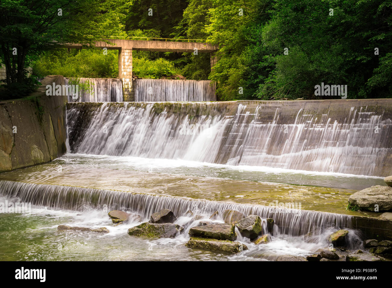 Rapid mountain river in a succession of waterfalls with long exposure ...