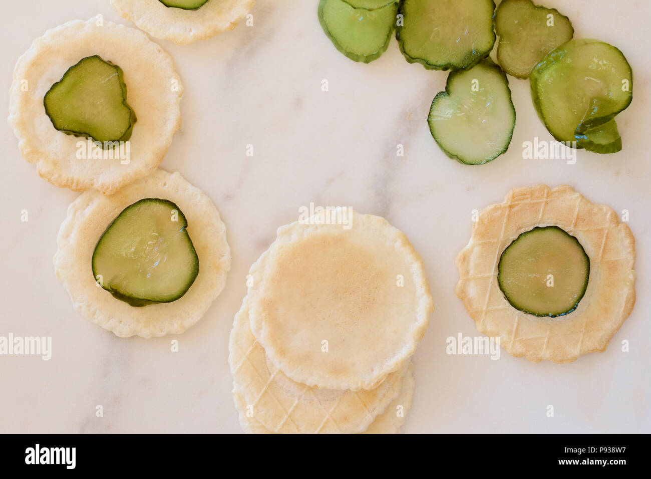 Savoury biscuits with spiced gherkin slices and cheese Stock Photo - Alamy