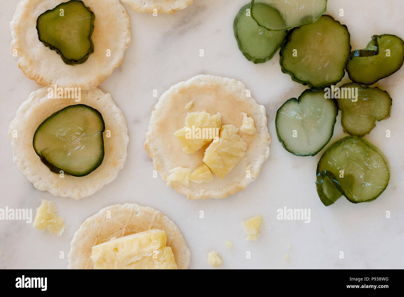 Savoury biscuits with spiced gherkin slices and cheese Stock Photo - Alamy