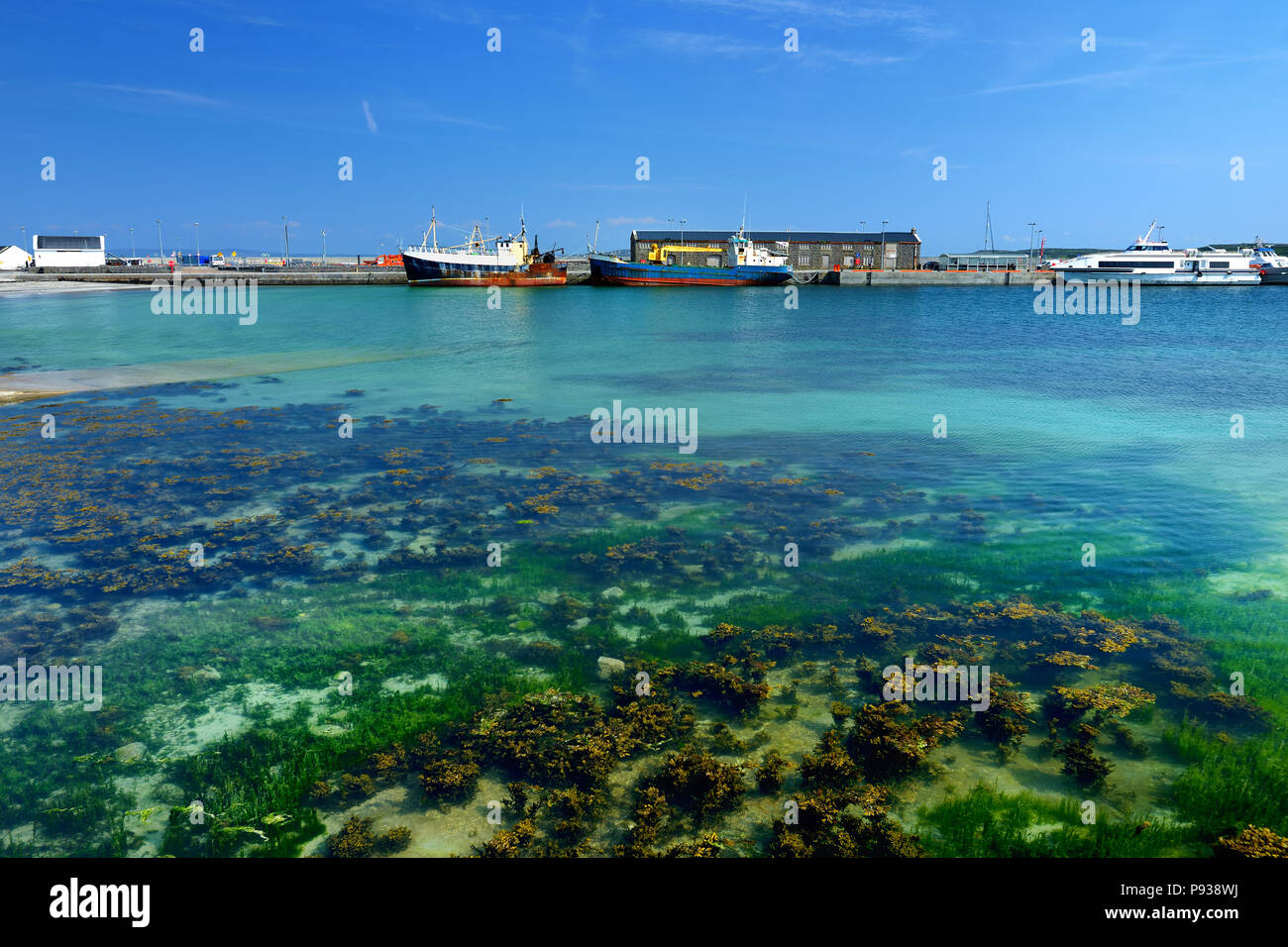 Blue waters in harbor of Kilronan of Inishmore, the largest of the Aran ...