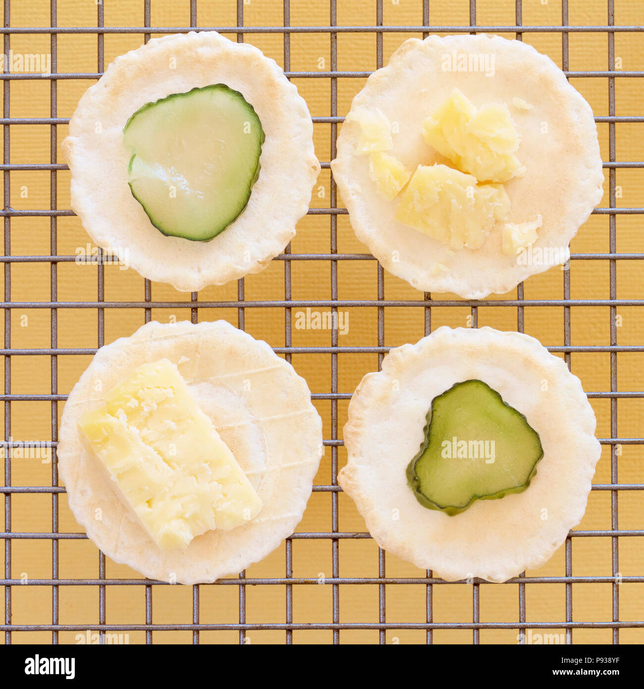 Savoury biscuits with spiced gherkin slices and cheese Stock Photo - Alamy