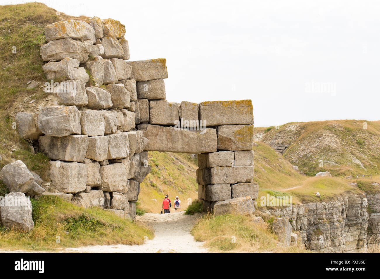Views of a stone arch on the coastal path that runs around the ...