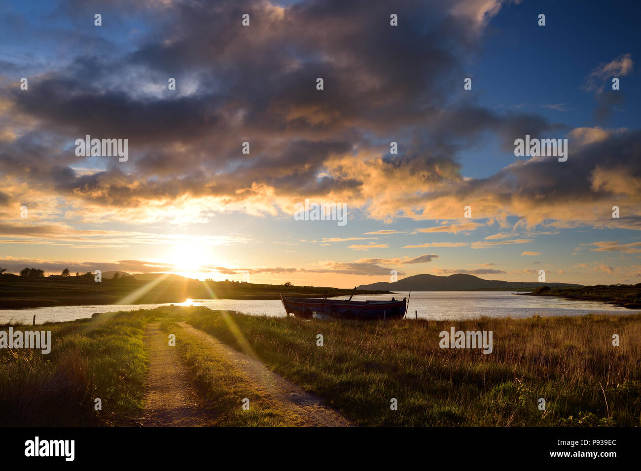 Old boat left on a small beach along the Ring of Kerry route. Rugged ...