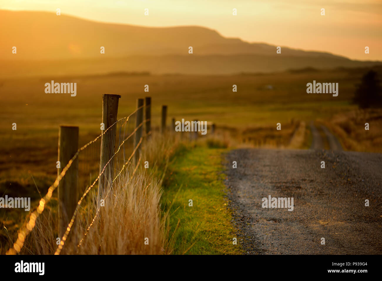 Beautiful sunset in Connemara. Scenic Irish countryside road leading ...