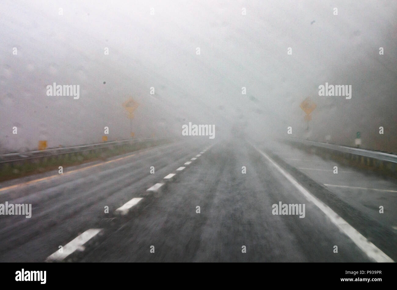 Fog hangs over the road on a rainy morning at Fancy Gap Va along ...