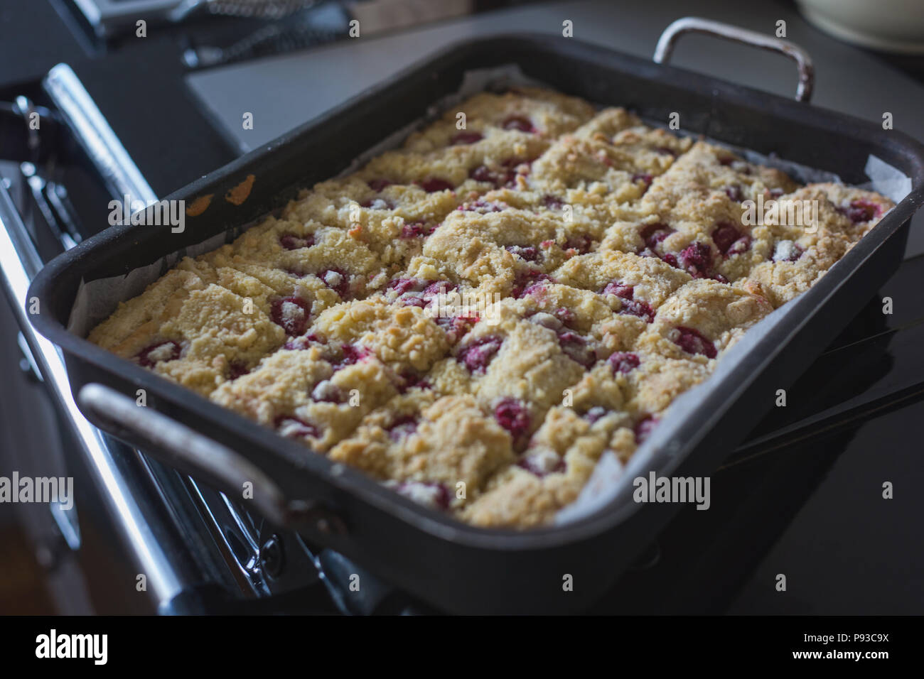 Raspberry and white chocolate crumble tray bake Stock Photo - Alamy