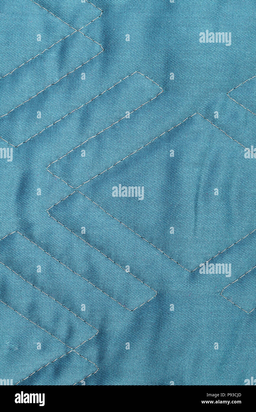Cyan quilted fabric texture with geometric pattern Stock Photo - Alamy