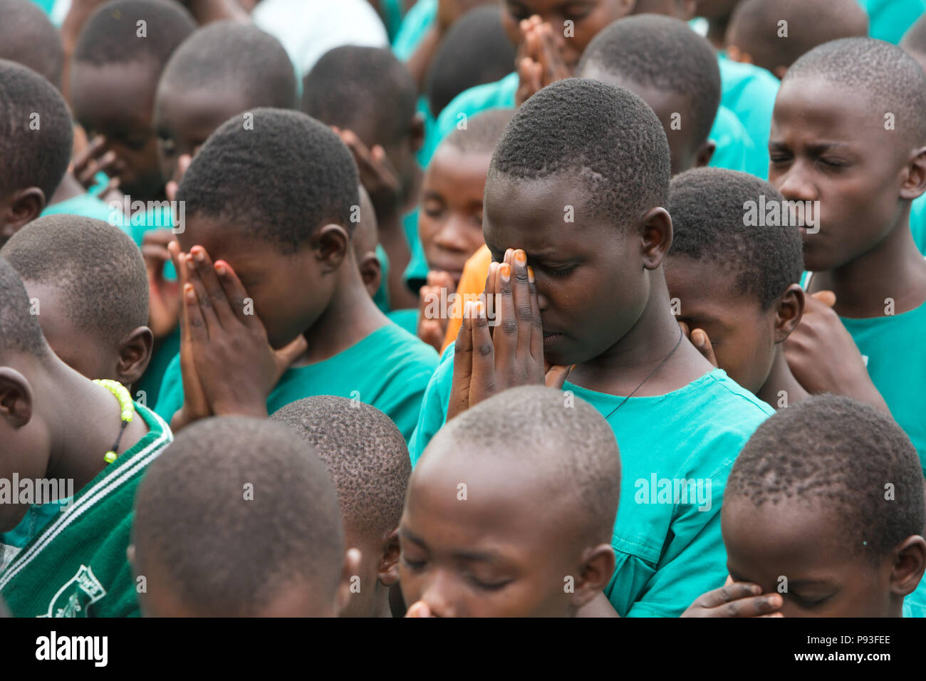 Bombo, Uganda - Praying students at the school appeal in the schoolyard ...