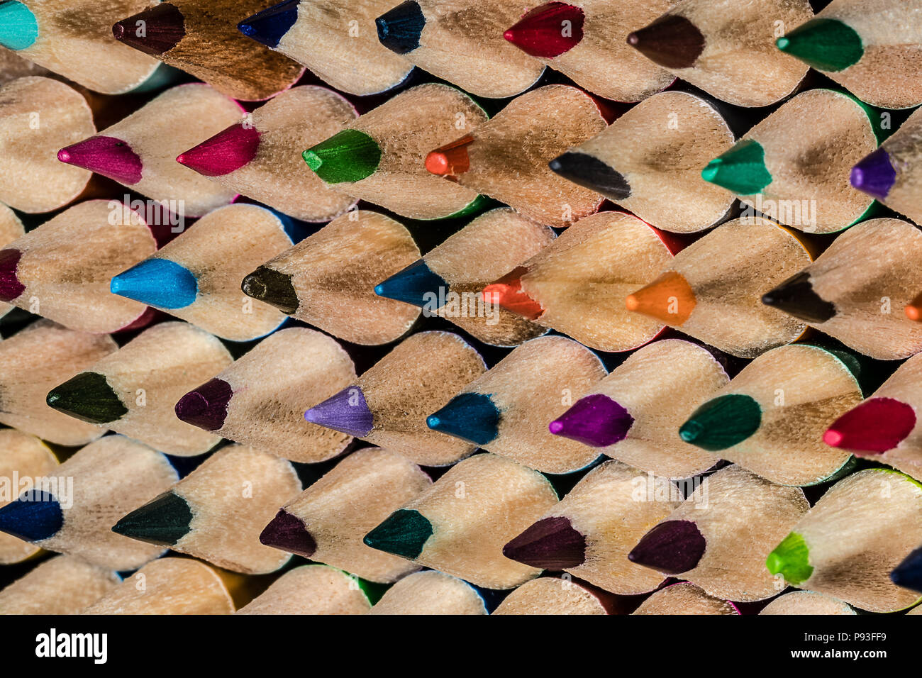 A tight Macro close up of Colored Pencil sharpened points in an orderly stack ready to use. Very ...