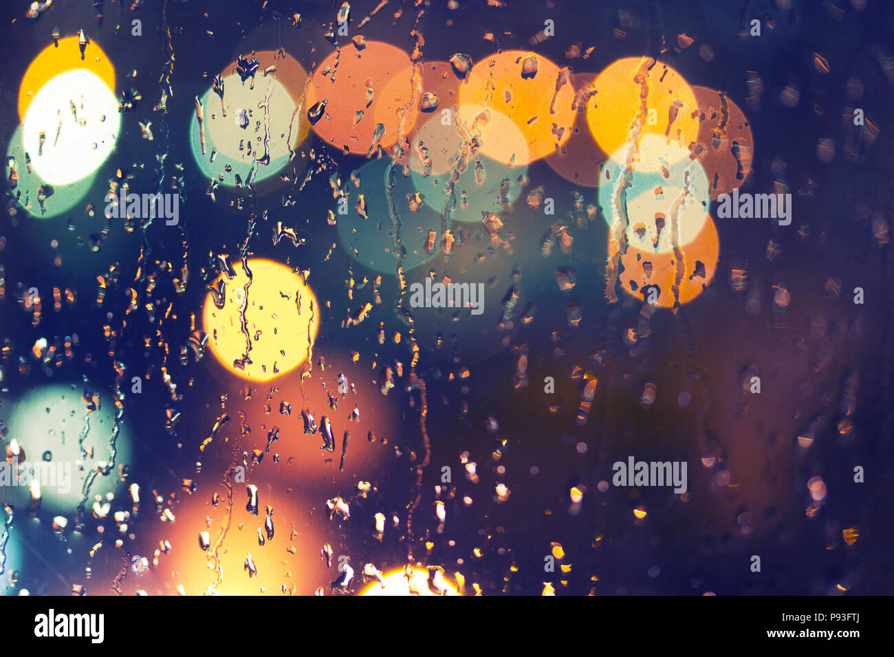 Drops of rain on window, night. blurred light Stock Photo - Alamy