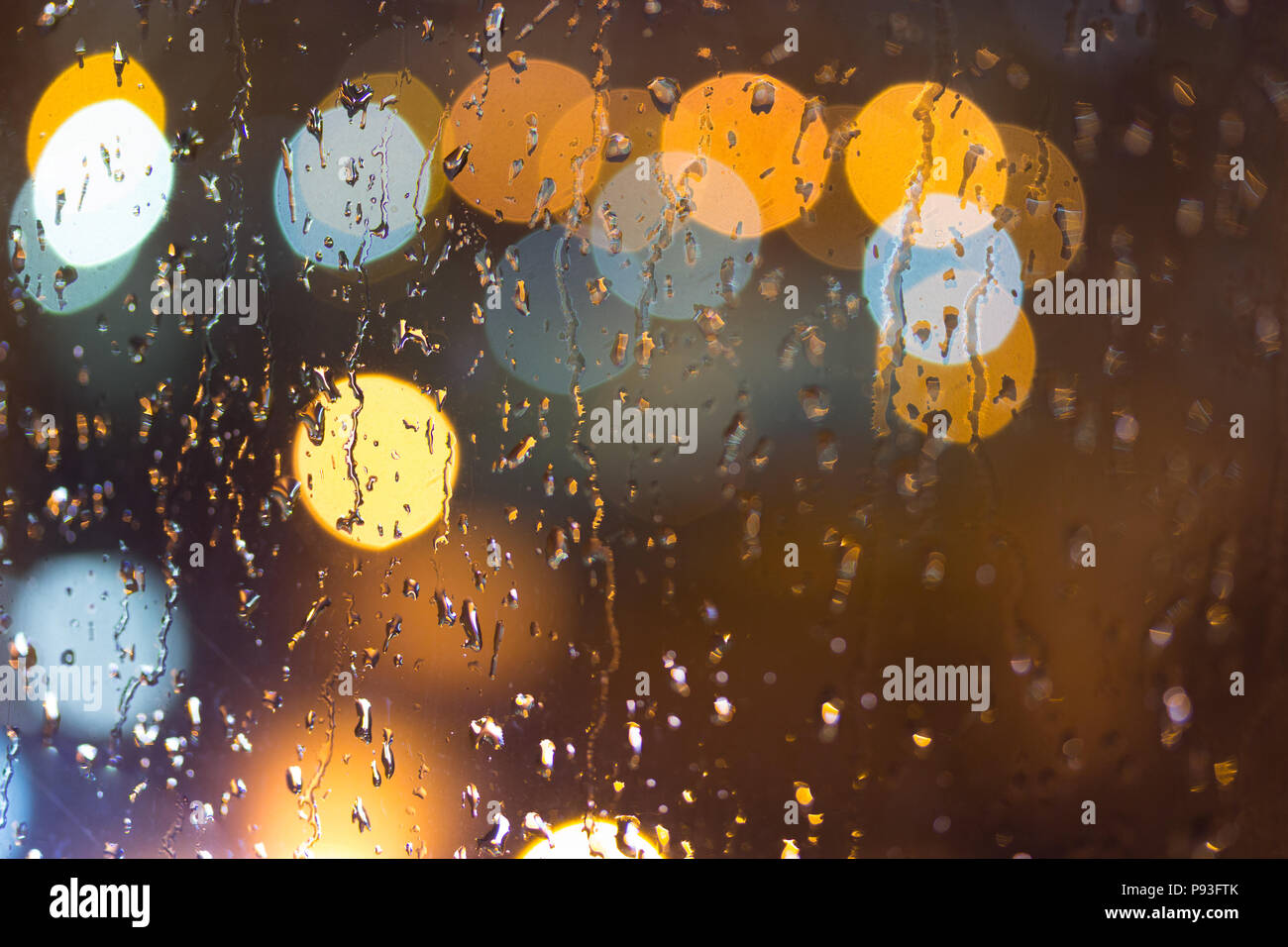 Drops of rain on window, night. blurred light Stock Photo - Alamy