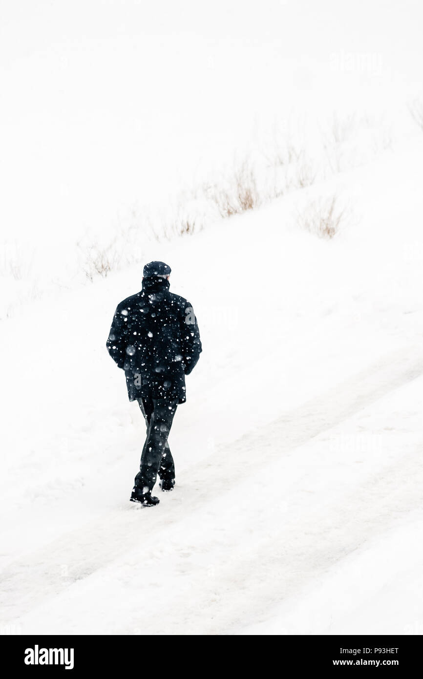 Man walking the road in extreme snow and Cold Stock Photo - Alamy