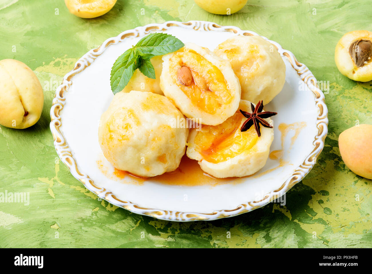 Fruit dumplings with apricot and spicy syrup Stock Photo - Alamy