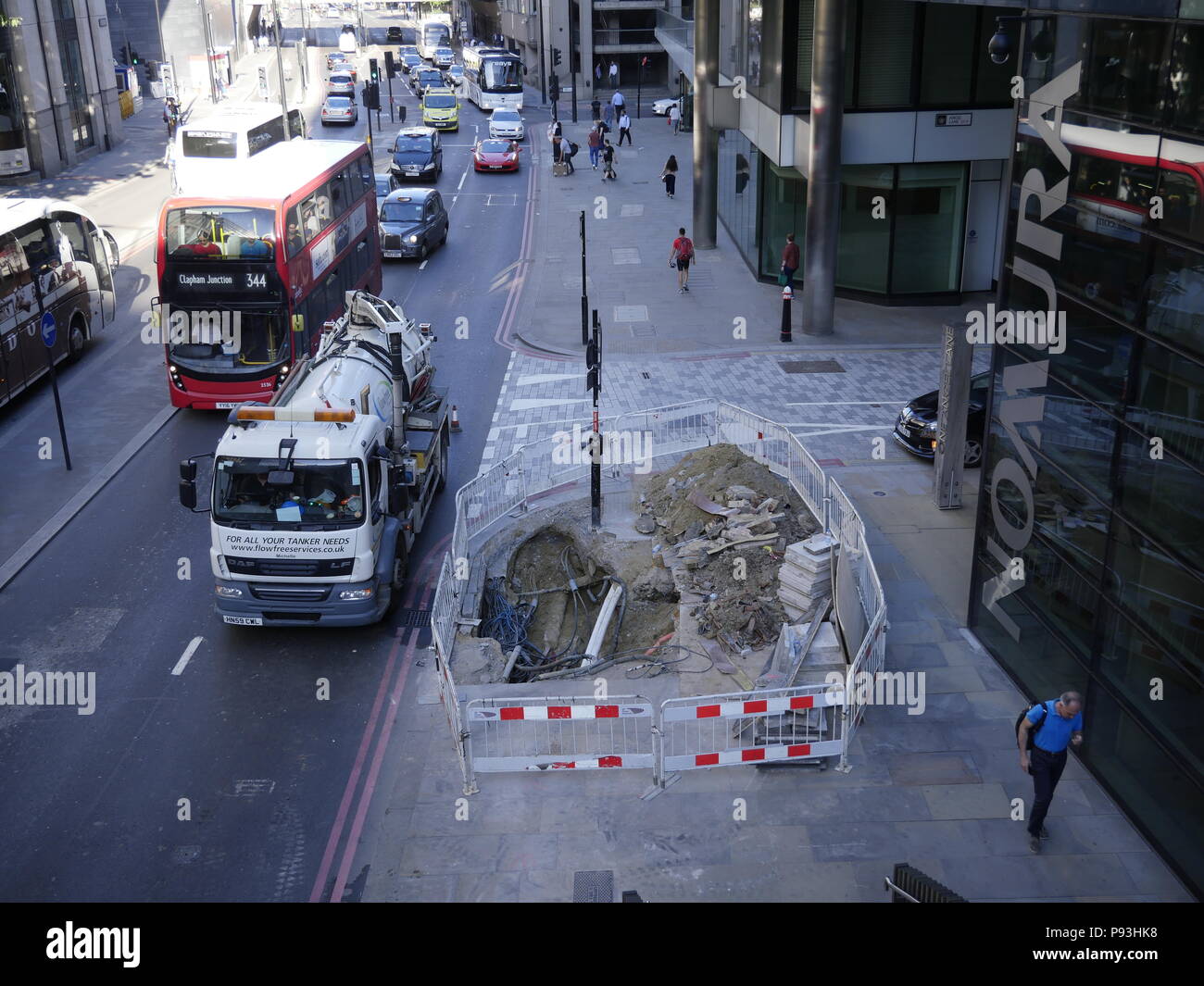 Road works Hole in pavement, dug for access to telecommunications ...