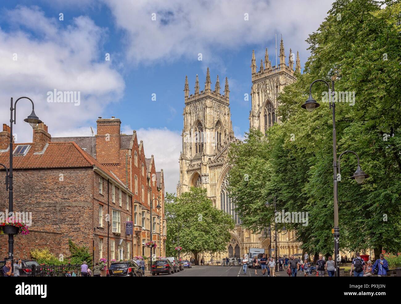 The west towers of York Minster from Duncombe Place. Brick buildings ...