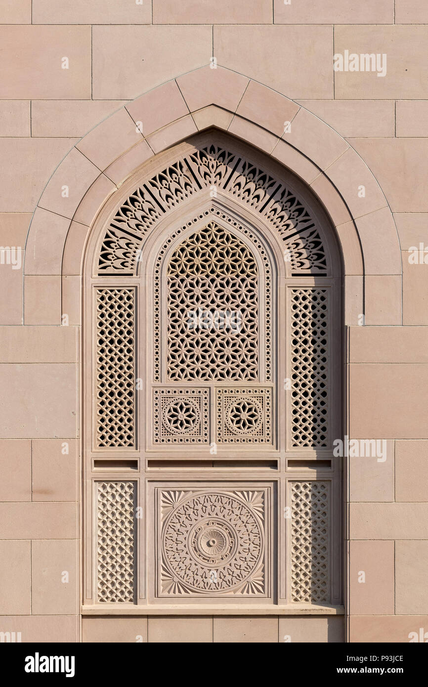 Intricateley carved stone window on the exterior wall of Sultan Qaboos ...