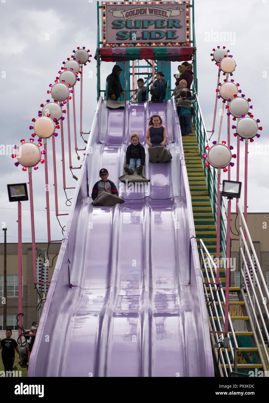Children ride the “Golden Wheel Super Slide” during the 3rd annual ...
