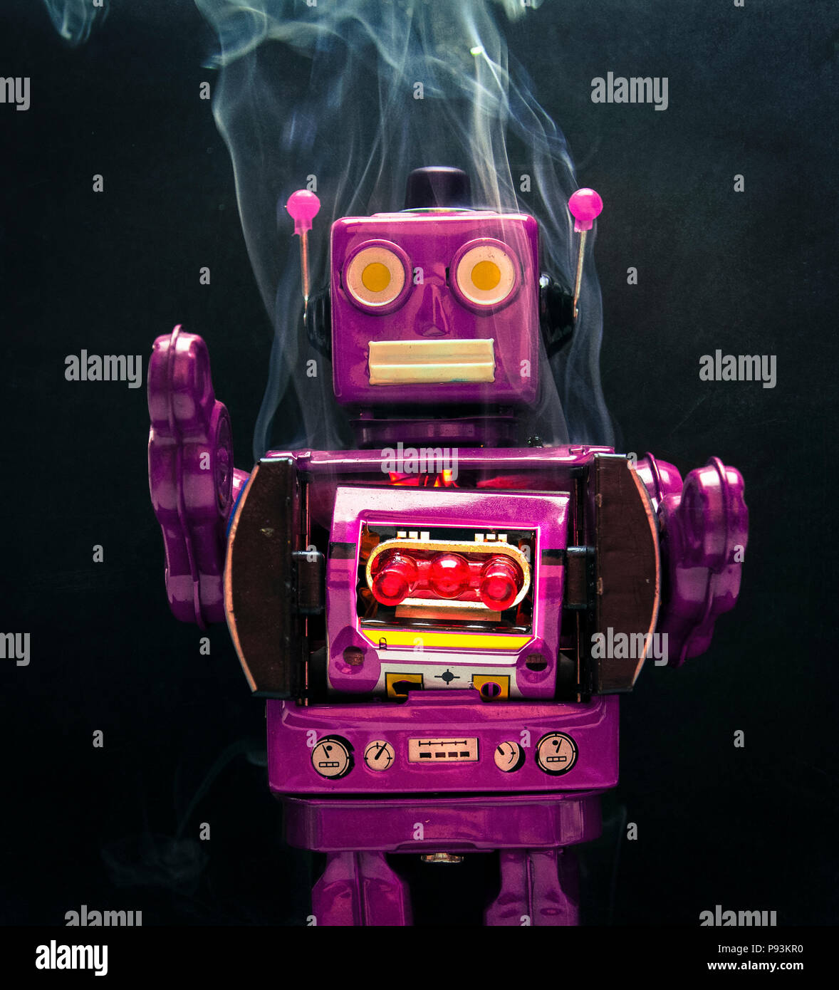 mad smoking purple robot on black background macro Stock Photo - Alamy