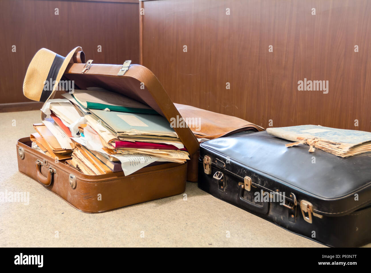 Straw hat is hanging on edge, of old fashioned suitcase made from ...