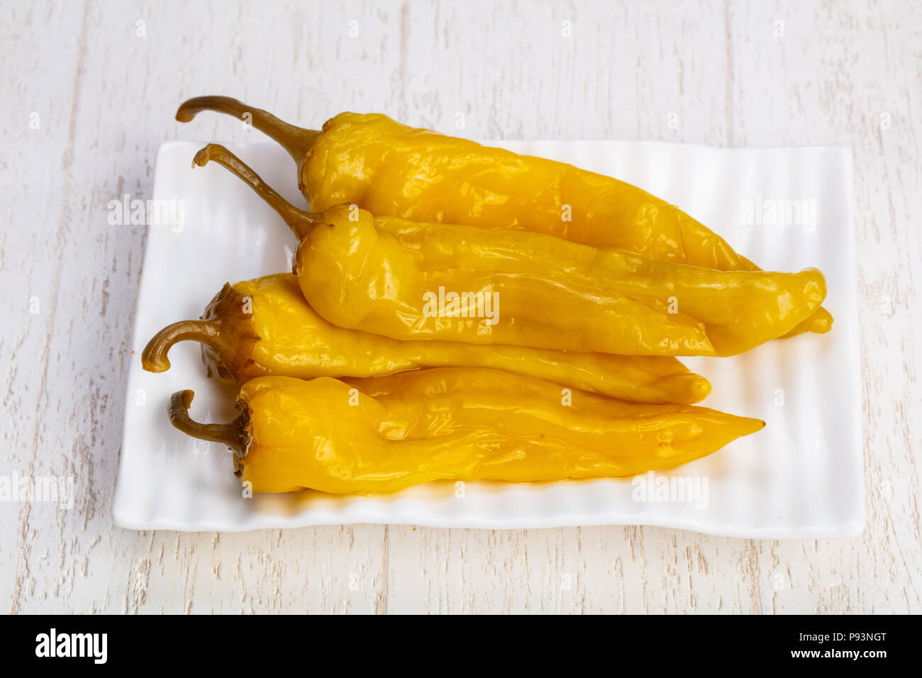 Tasty plate of salty pickled peppers Stock Photo - Alamy