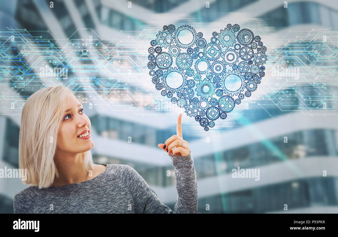 Portrait of smiling woman pointing finger up showing a gear heart ...