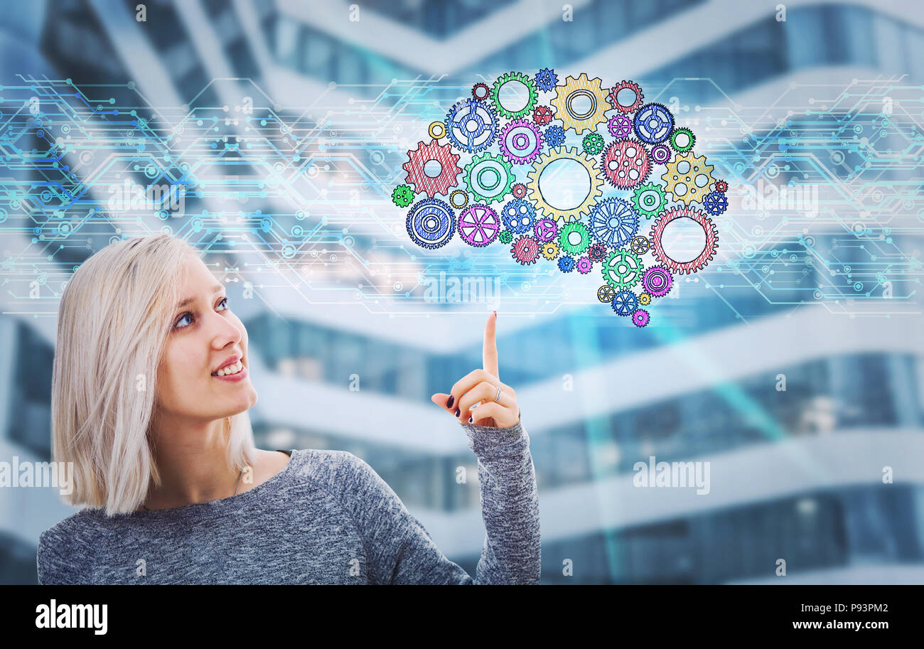 Portrait of smiling woman pointing finger up showing a gear brain ...