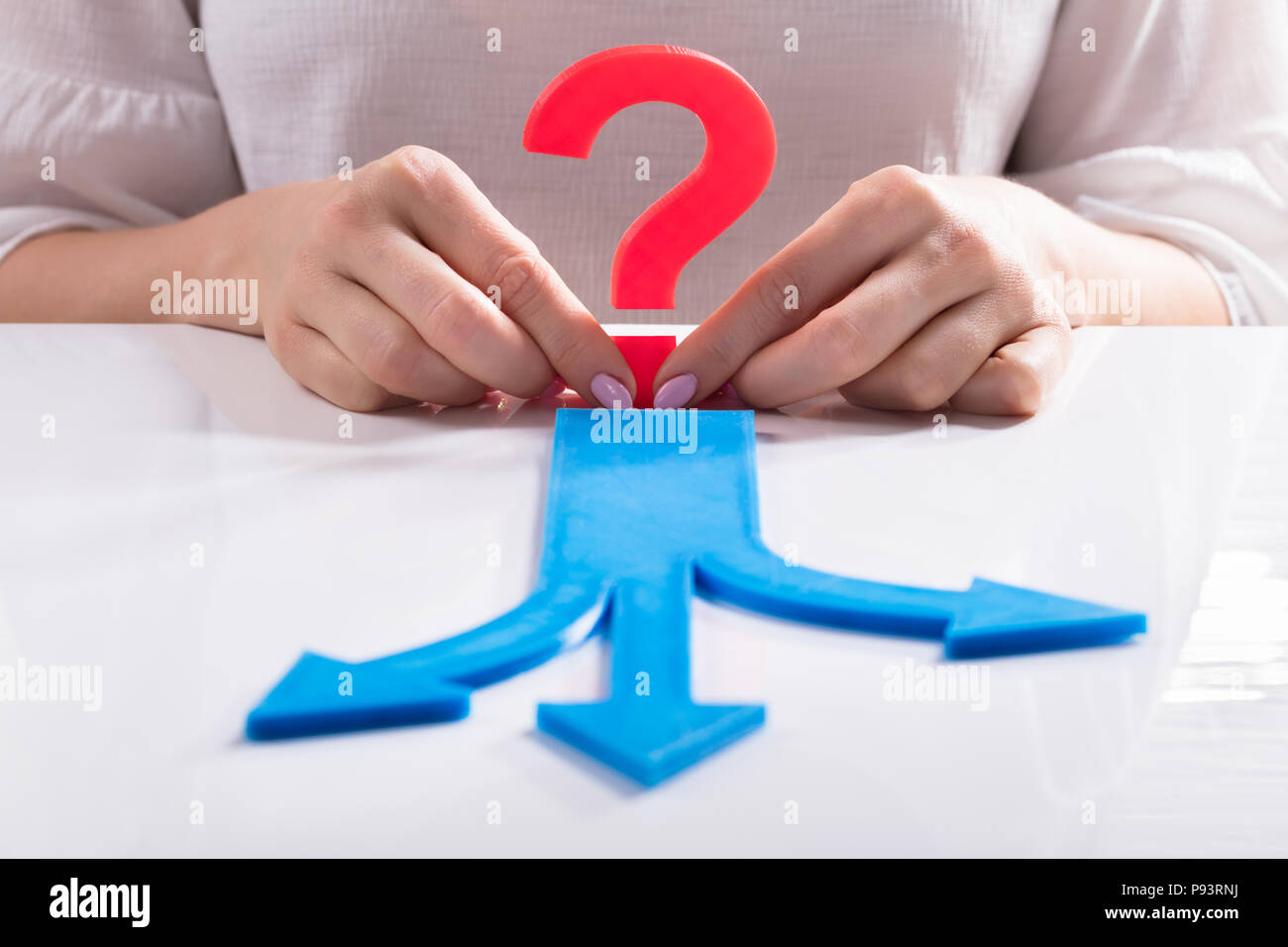 Blue Arrows Showing Various Directions In Front Of Woman's Hand Holding ...